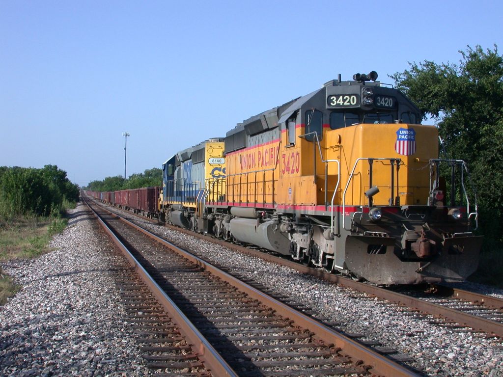 UP 3420 CSX 8140 26Aug2004 Waiting SB on the siding with empty gondolas
